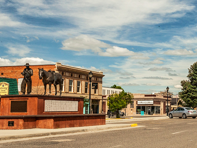 Thermopolis' downtown features a cowboy and horse statue, celebrating the town's Western heritage under Wyoming's vast blue skies.