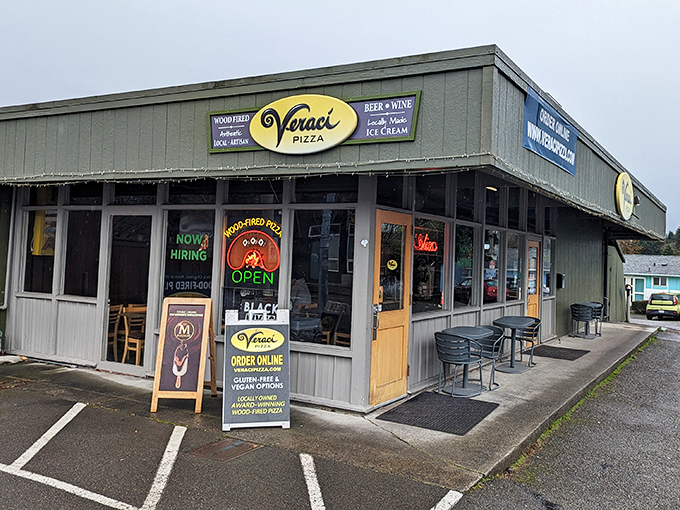 Strip mall exteriors often hide the most authentic treasures, where wood-fired ovens create pure pizza poetry.