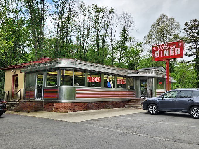 The Village Diner's stainless steel shell gleams like your grandmother's prized serving platters, only with better hash browns inside.