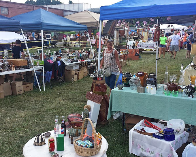 Outdoor vendor tents create a festive flea market atmosphere where locals gather to buy, sell, and swap their finds.