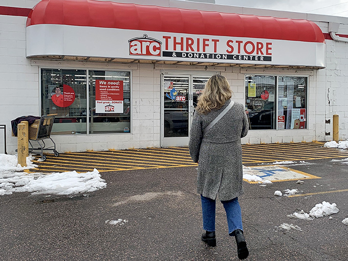 The red awning of opportunity! Arc Thrift Store stands ready for bargain hunters, even in Colorado's unpredictable weather.