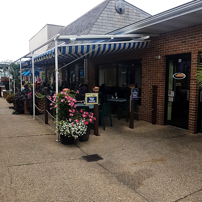 Brick charm with striped awnings creates the perfect lunch backdrop - where quality meets that relaxed shore vibe.