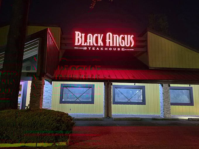 That crimson glow beckons like a beacon for beef lovers seeking quality without the downtown price tag.