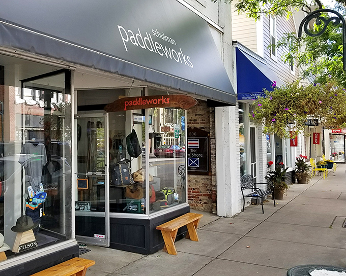 Paddleworks shop window displays outdoor gear like jewelry, tempting adventurers to trade their office chairs for kayak seats and conference calls for loon calls.
