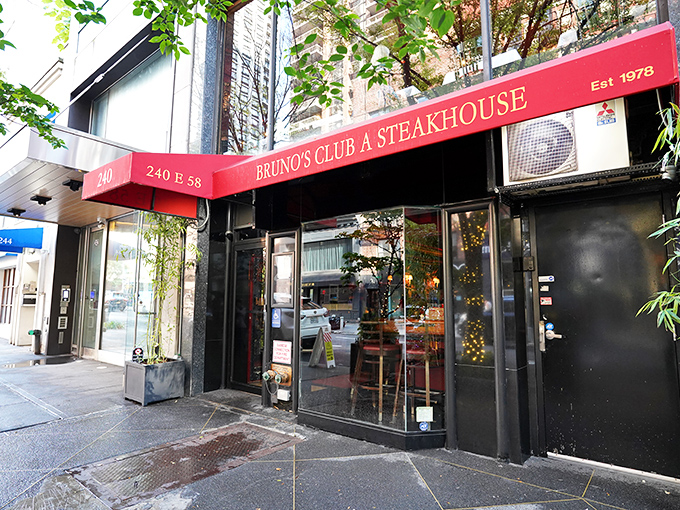 The red awning signals what lies within: a carnivore's sanctuary where meat and martinis flow with equal precision.
