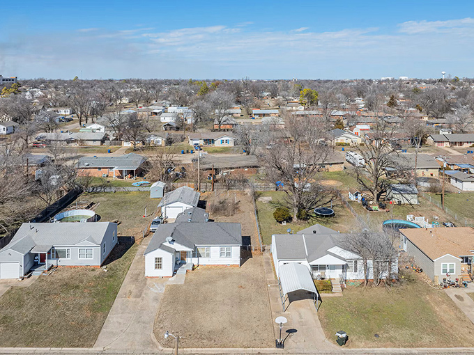 Tree-lined streets create natural canopies over homes where neighbors still wave hello.
