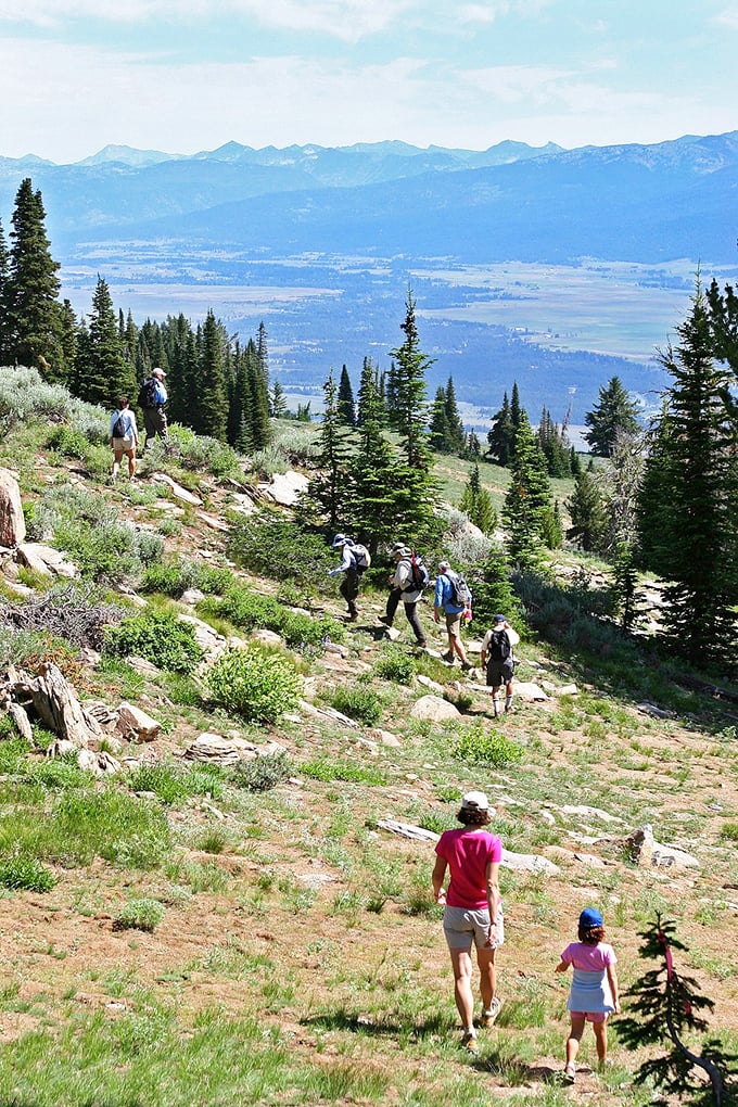 Hikers making their way down the mountain trail, proving that the best views in Idaho are earned one step at a time.