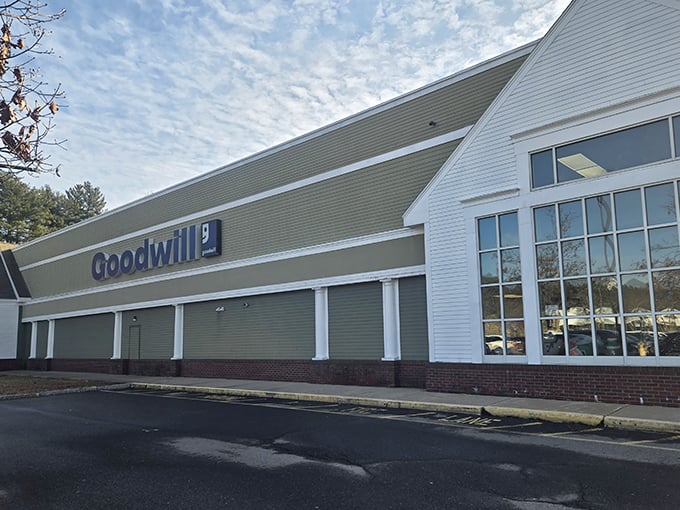The distinctive green and white Goodwill building stands ready for treasure hunters and bargain seekers alike.