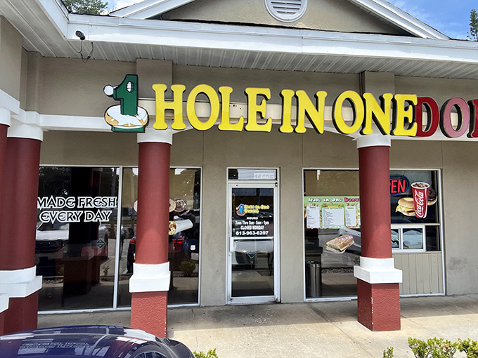 The red columns frame the entrance like a portal to a world where calories are just numbers and joy is measured in sprinkles.
