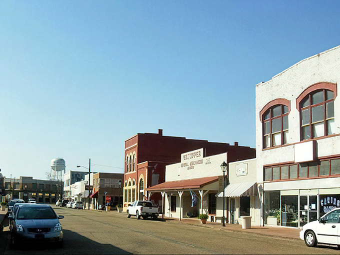 Vintage storefronts and colorful awnings create a Main Street scene straight from a Norman Rockwell painting.