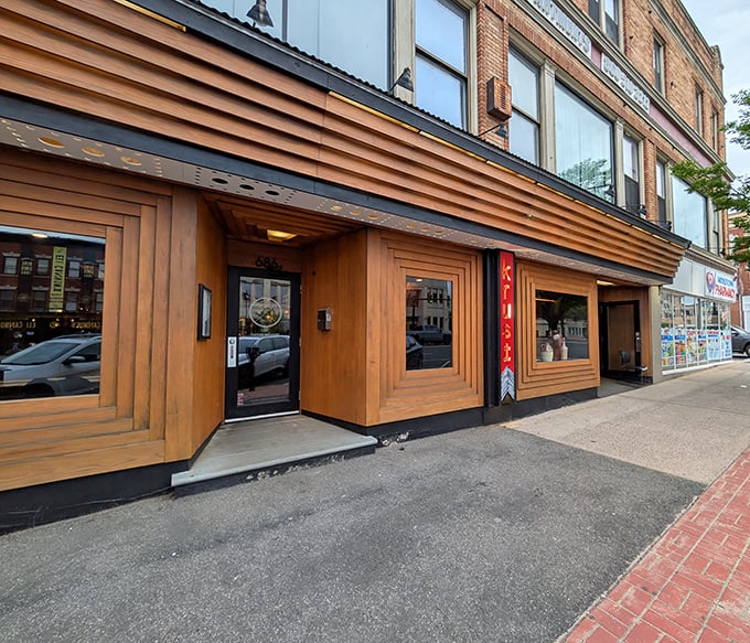 That modern wooden facade hints at the sophisticated pizza adventure waiting inside this Middletown gem.