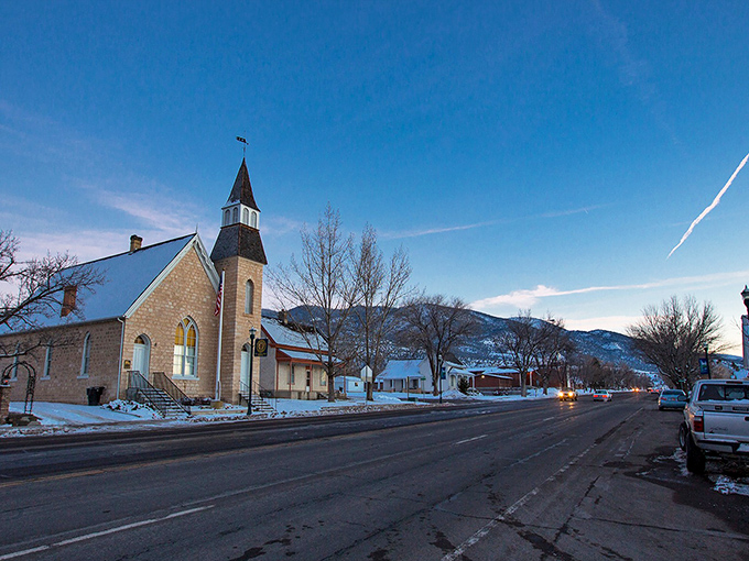 The historic church stands sentinel over Manti's main street, where stained glass catches the golden Utah sunlight.