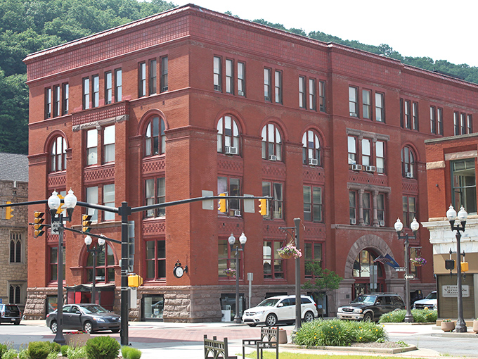The impressive red brick architecture of Oil City houses budget-friendly living spaces with vintage character. Where your retirement dollars stretch further than those elastic-waist pants you finally surrendered to!
