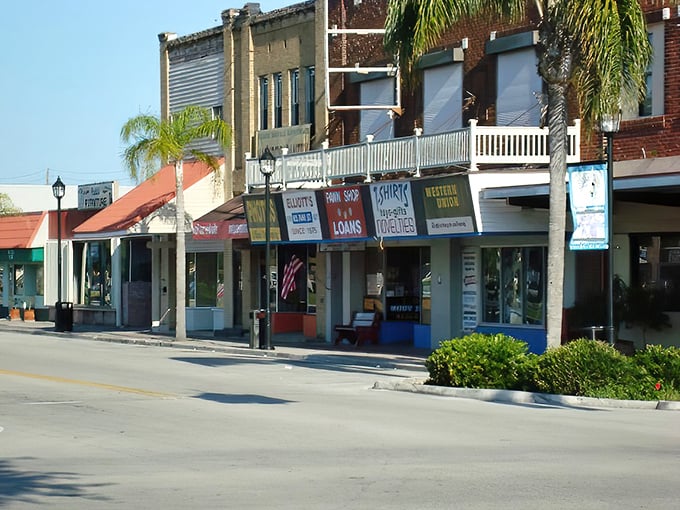 Forget the modern plazas&mdash;this is the authentic heartbeat of a town. A row of weathered storefronts where every sign tells a story of commerce and community under the palms.