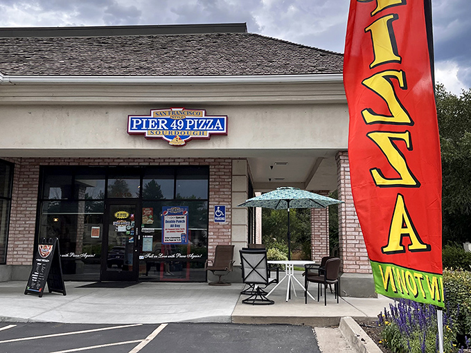 That classic pizza flag waves like a beacon for anyone seeking authentic, no-nonsense Italian goodness.