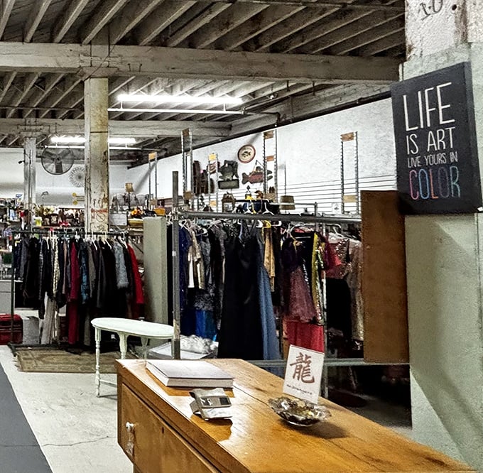 "Life is Art" proclaims the sign at Queen City Flea Market. Racks of vintage clothing wait for their second chance at fashion stardom.