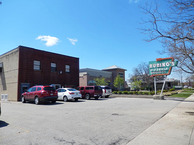 Rain, shine, or apocalypse - Rubino's Pizza sign beckons the faithful. Worth standing in any weather for these legendary thin pies.