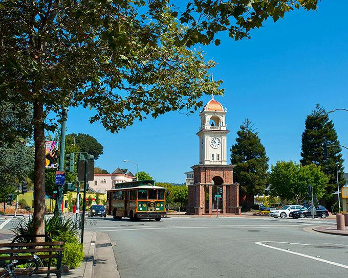 SLO's iconic downtown trolley passes the historic clock tower &ndash; small-town charm with just the right amount of California cool.