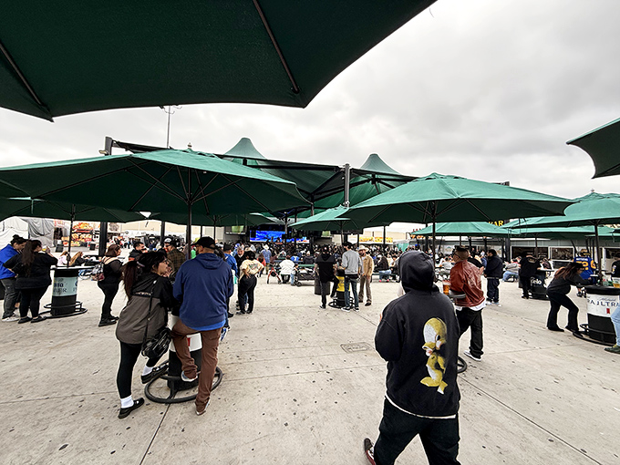 Green umbrellas provide shade while bargain hunters explore Santa Fe Springs' weekend shopping wonderland.