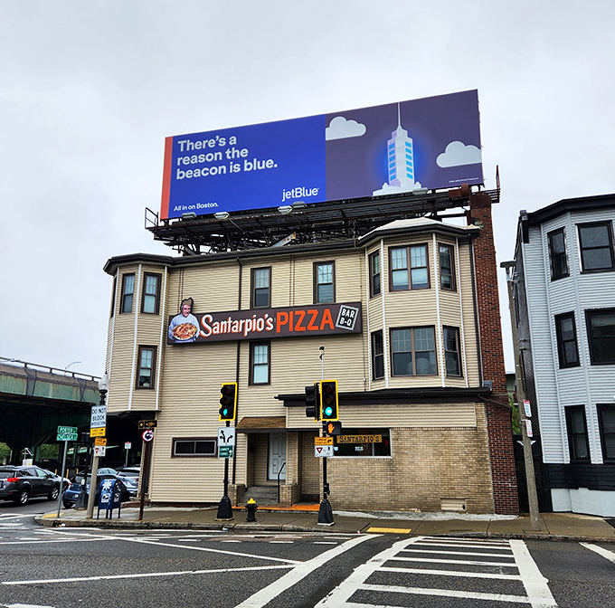 That iconic chef holding pizza on Santarpio's sign has been making Bostonians hungry for generations.