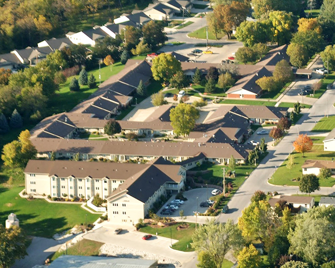 The aerial view reveals Scenic Living's thoughtful campus design &ndash; a neighborhood within a neighborhood, embraced by Iowa's landscape.