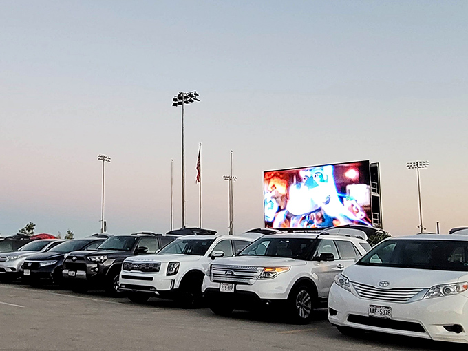 Modern drive-in, timeless joy! The Milky Way's LED brilliance illuminates a perfect row of family vehicles as twilight embraces movie night.