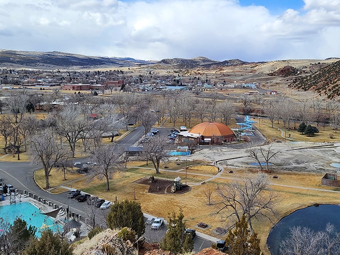 Thermopolis from above, showing Hot Springs State Park with its mineral pools nestled among rolling hills and mountain views.