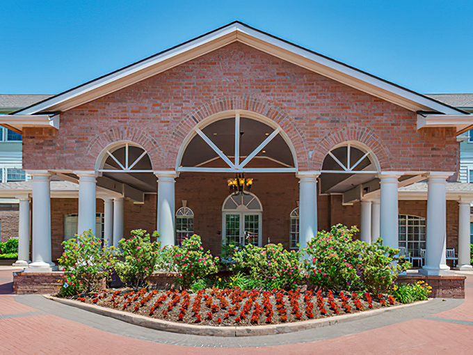 Stately entrance with columns and brick work that makes every arrival feel like coming home.