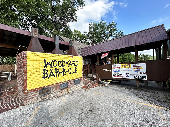 The bright yellow "Woodyard Bar-B-Que" sign pops against brick and wood. It's like a treehouse for grown-ups who love smoked meat.