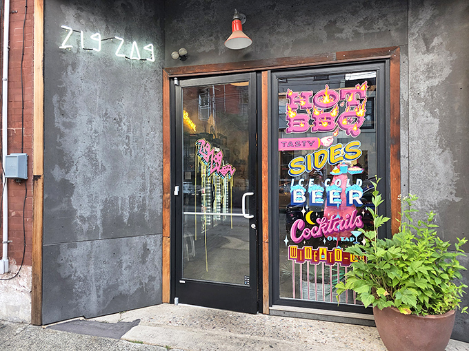 The colorful window signs hint at the flavor explosion waiting inside this unassuming Philadelphia BBQ joint.