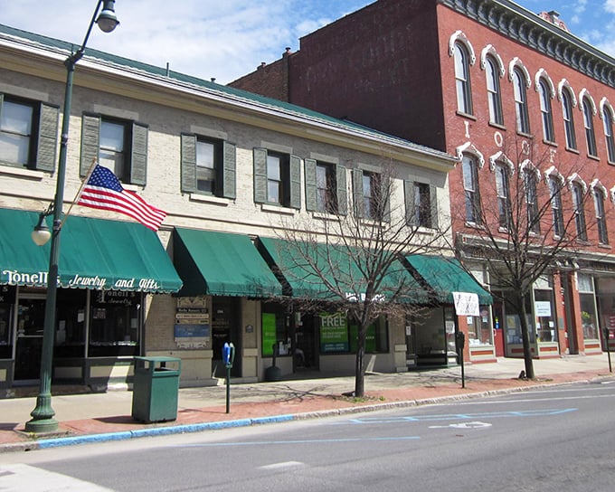 American flags flutter along Main Street, where locally-owned shops have survived the big-box invasion that claimed so many small-town centers.