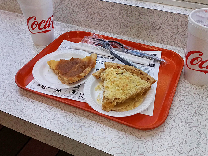 Two slices of pie that could make even your grandmother nervous about her baking reputation. The newspaper underneath? Tomorrow's headlines: "Local Eats Heaven."