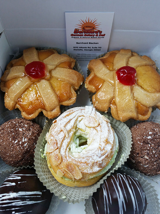 A box of German pastry perfection that makes grocery store donuts look like they need therapy. That cream-filled beauty center stage is calling your name.