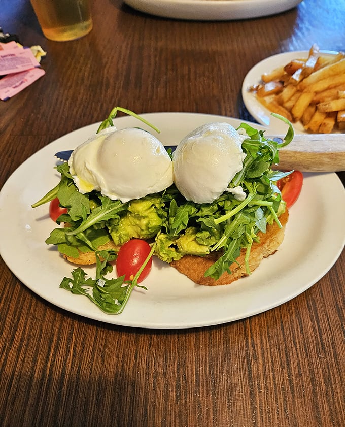 Avocado toast gets the royal treatment with perfectly poached eggs perched like crowns atop a kingdom of greens and grains.