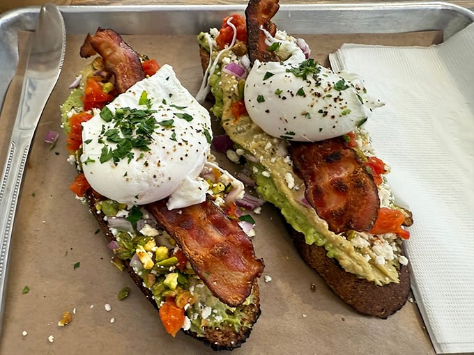 Avocado toast that doesn't require a second mortgage! Perfectly poached eggs perch atop a mountain of green goodness like tiny breakfast royalty.