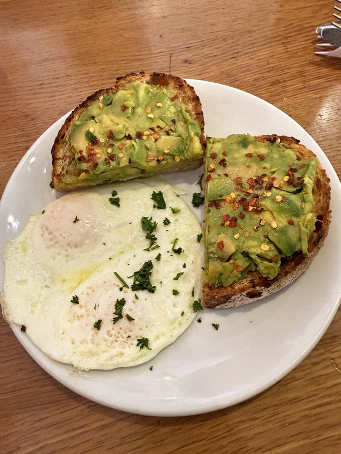Avocado toast that makes millennials' obsession completely understandable, paired with an egg that's cooked to sunrise perfection.