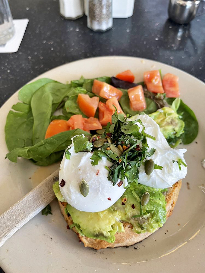 Avocado toast that even your boomer dad would approve of&mdash;topped with perfectly poached eggs, fresh herbs, and enough greens to feel virtuous about your choices.