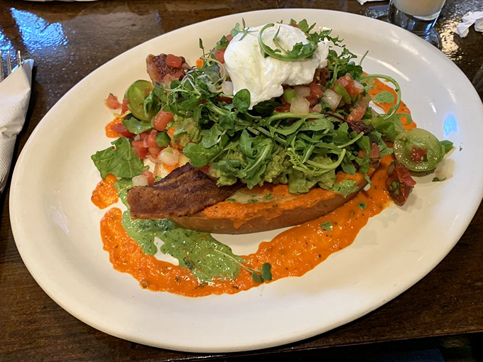 A colorful mountain of freshness where avocado toast gets the royal treatment. Microgreens and vibrant sauces elevate this Instagram darling.