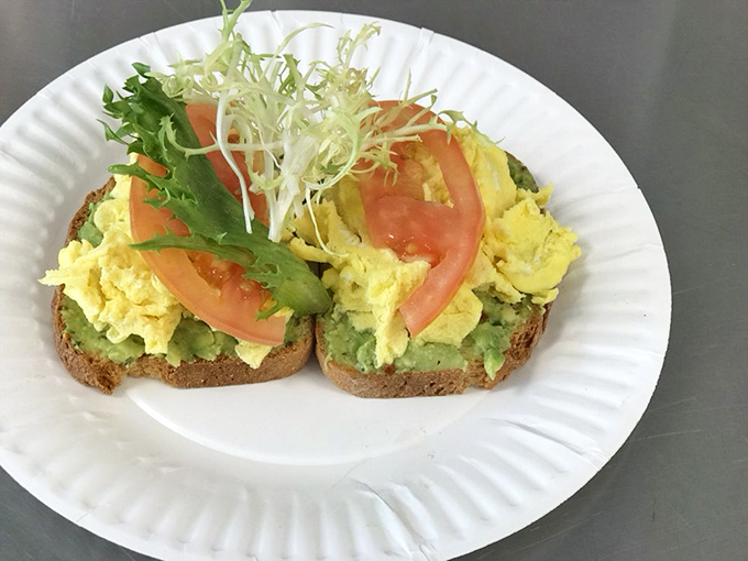 Avocado toast that actually justifies the hype&mdash;creamy green goodness topped with perfectly scrambled eggs and fresh tomato.