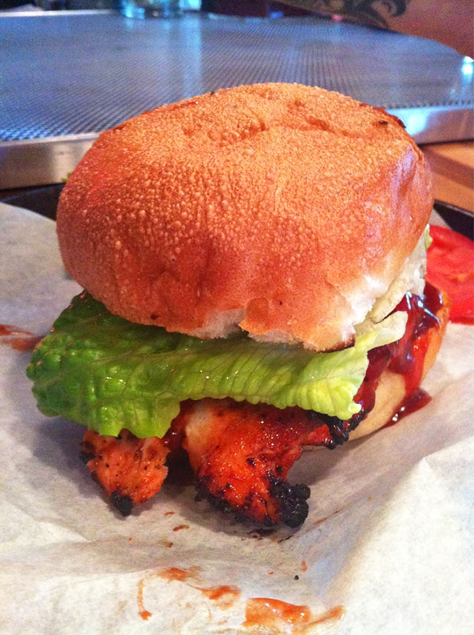 A chicken sandwich that proves BBQ isn't just a meat preparation—it's a philosophy where simplicity and flavor have a beautiful romance.