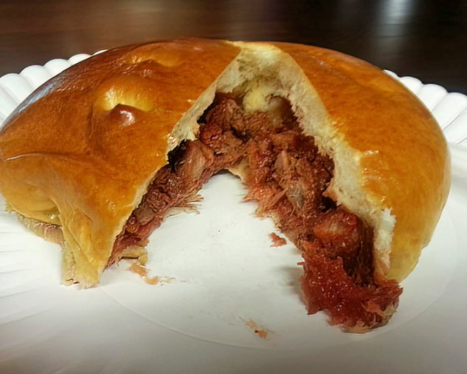 Cut into this BBQ pork bun and watch the savory filling peek out like it's been waiting to meet you.