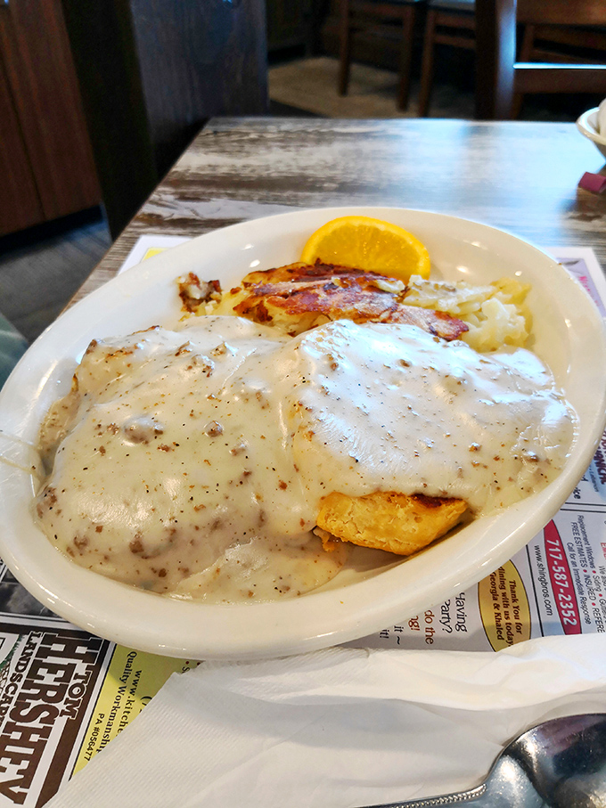 Biscuits swimming in gravy with a side of crispy bacon &ndash; the kind of plate that makes you want to hug the cook.