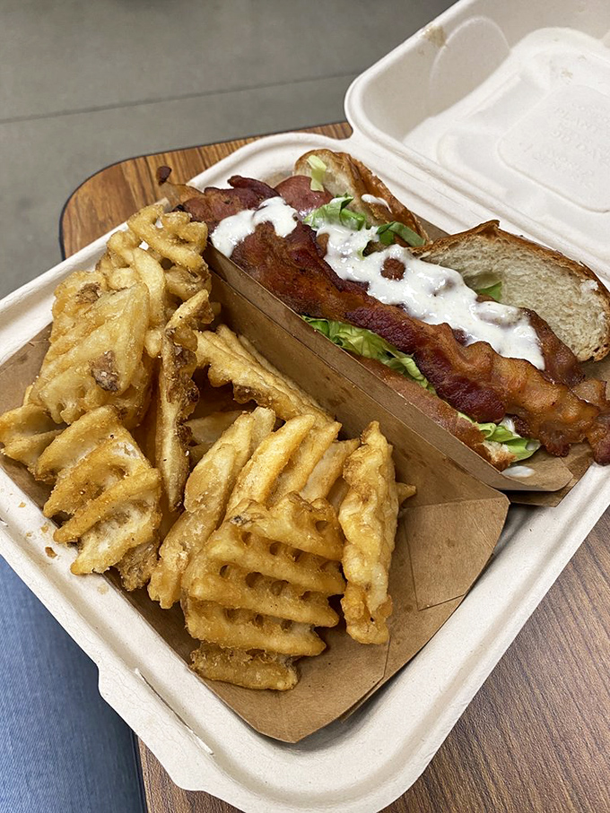 A hot dog that's dressed better than most people at the mall. Crispy bacon, fresh lettuce, and a sauce that ties everything together like a culinary conductor.