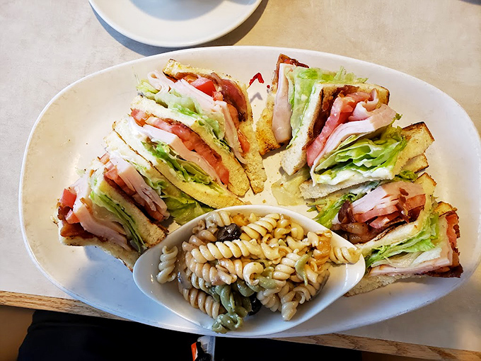 Not just any club sandwich—this architectural marvel of crisp bacon, fresh veggies, and toasted bread is arranged like it's posing for its LinkedIn profile picture.