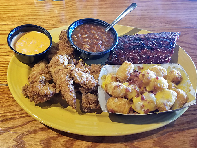 Barbecue nirvana achieved: tender ribs, crispy chicken tenders, and those tater tots smothered in cheese—a plate that makes diets weep in the corner.