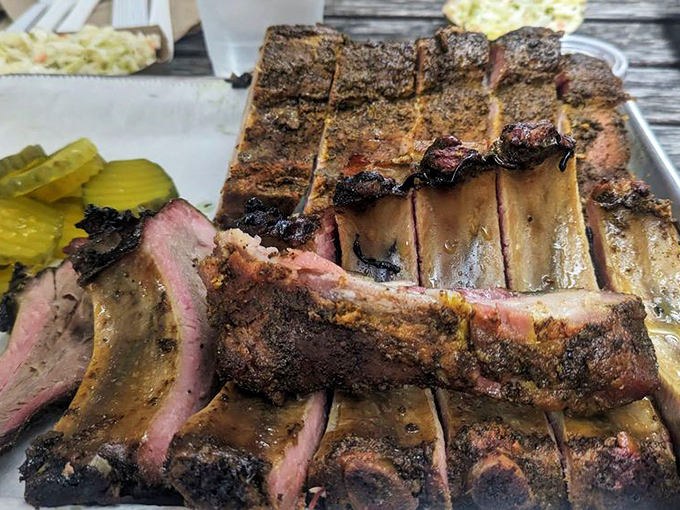 These ribs have that perfect pink smoke ring that separates barbecue artists from pretenders. The kind of meat that makes vegetarians question their life choices.