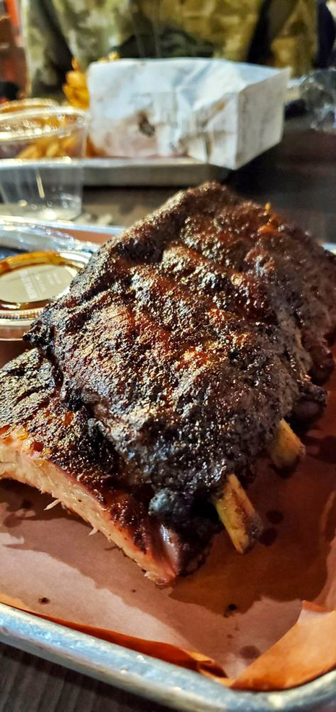 Baby back ribs so perfectly rendered they make you wonder if you've been eating the wrong food your entire life. The smoke ring doesn't lie.