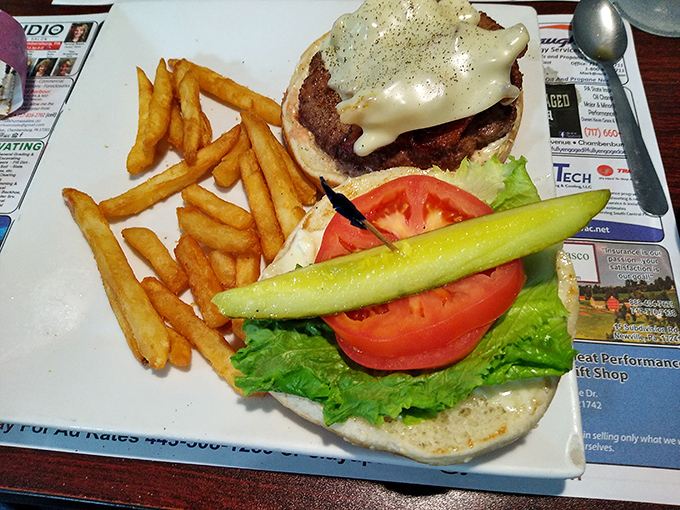 A proper diner burger doesn't need fancy toppings&mdash;just fresh vegetables, melted cheese, and a pickle spear standing guard over those perfect fries.
