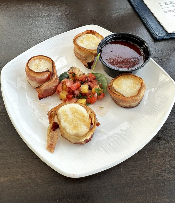 Bacon-wrapped scallops: where the ocean meets the smokehouse in a romance that would make Neptune himself blush with delight.