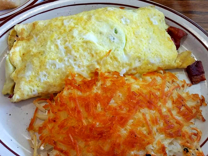 The perfect omelet isn't just about the eggs—it's about that crispy hashbrown sidekick that's been kissed by the flat-top until golden and irresistible.